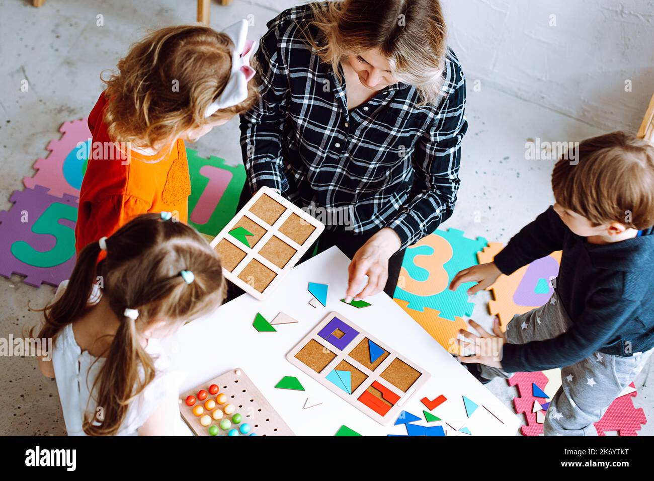 Development class for little children. Female teacher with children ...