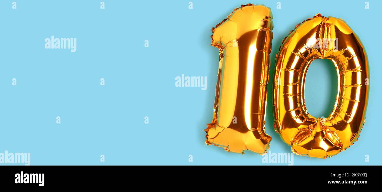 Banner with number 10 golden balloon with copy space. Ten years ...