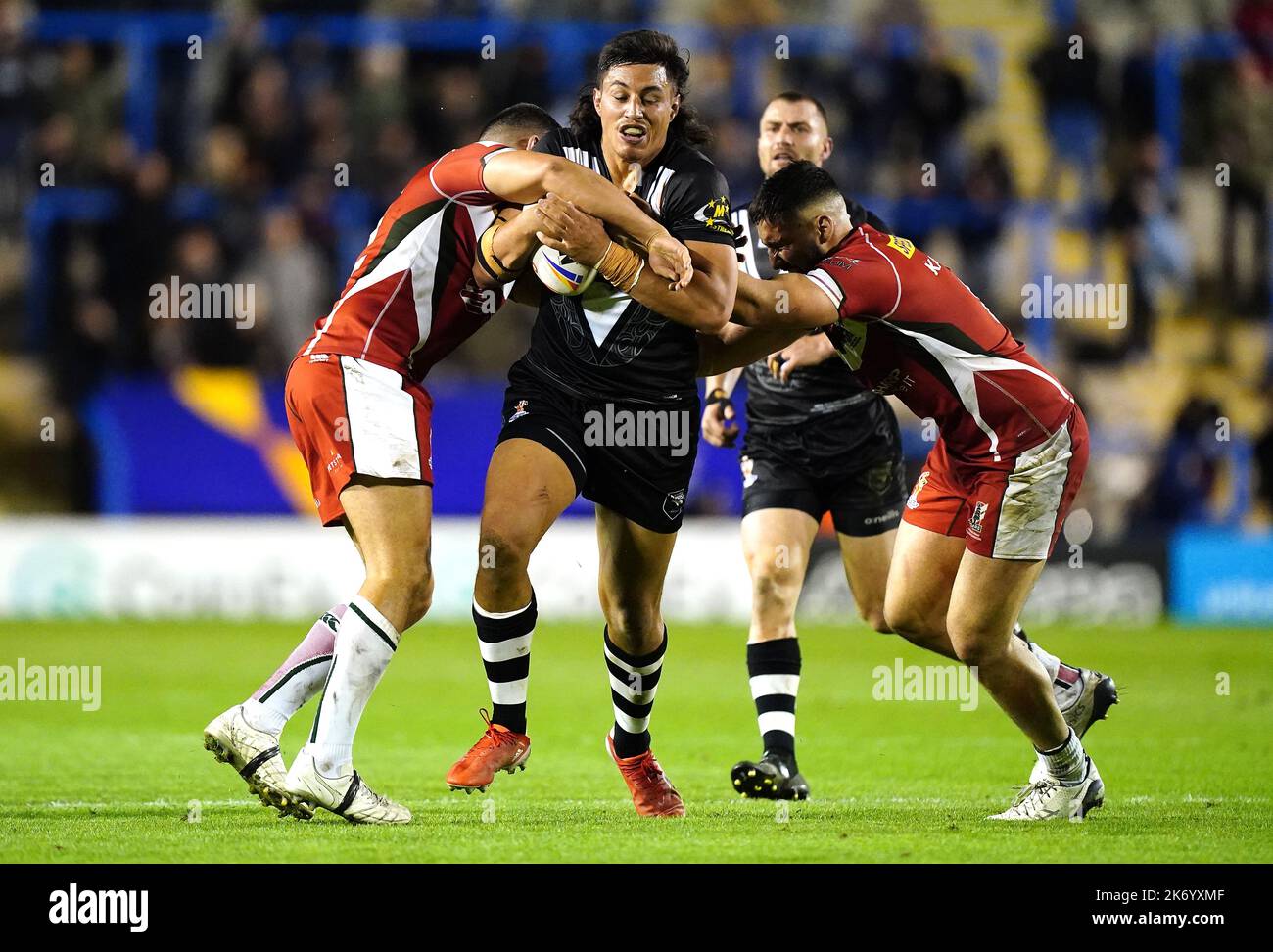 New Zealand's Joseph Tapine (centre) is tackled by Lebanon's Charbel ...