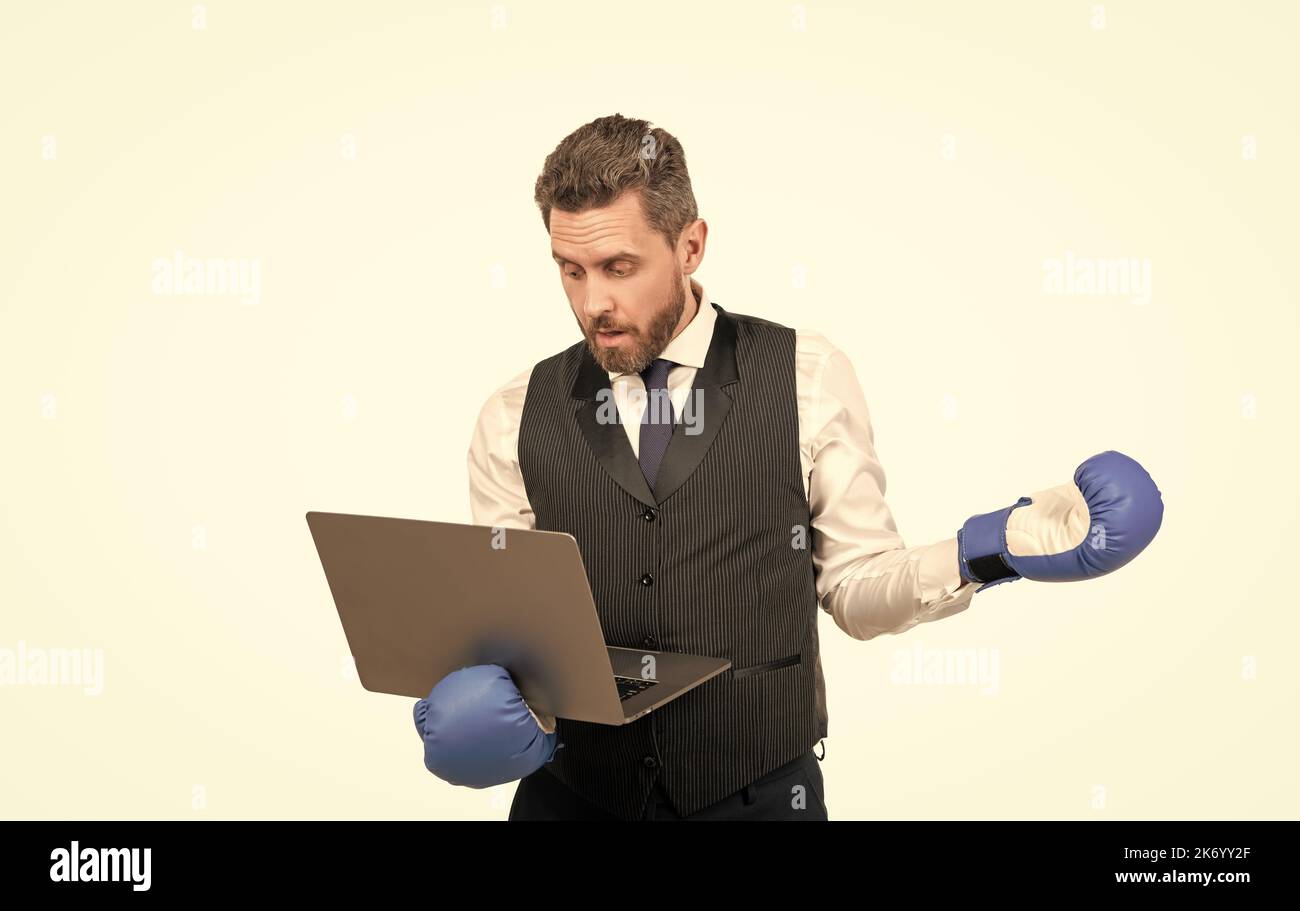 amazed man in boxing gloves and suit hold laptop isolated on white ...