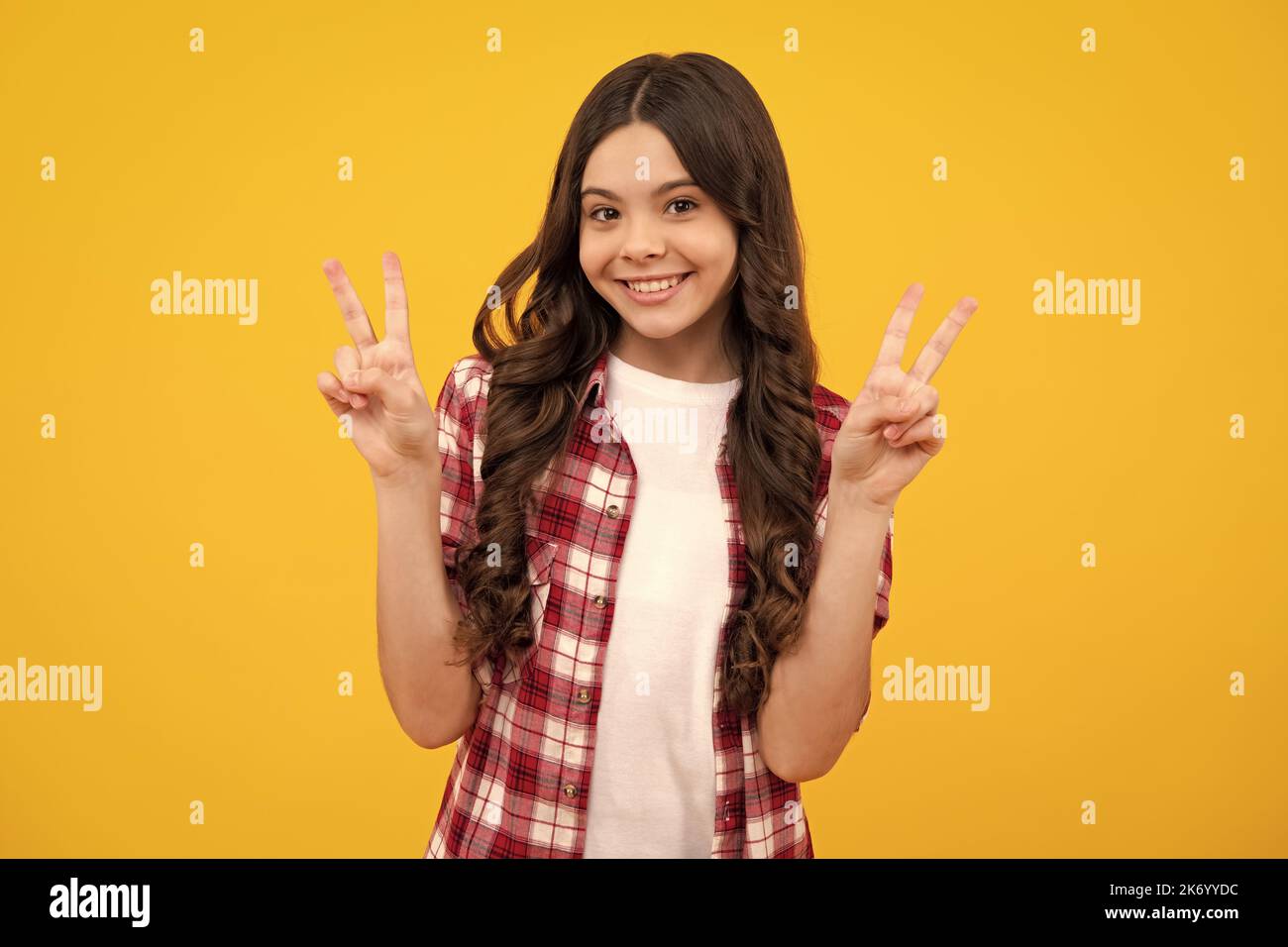 Teenager child girl standing over isolated yellow background showing ...