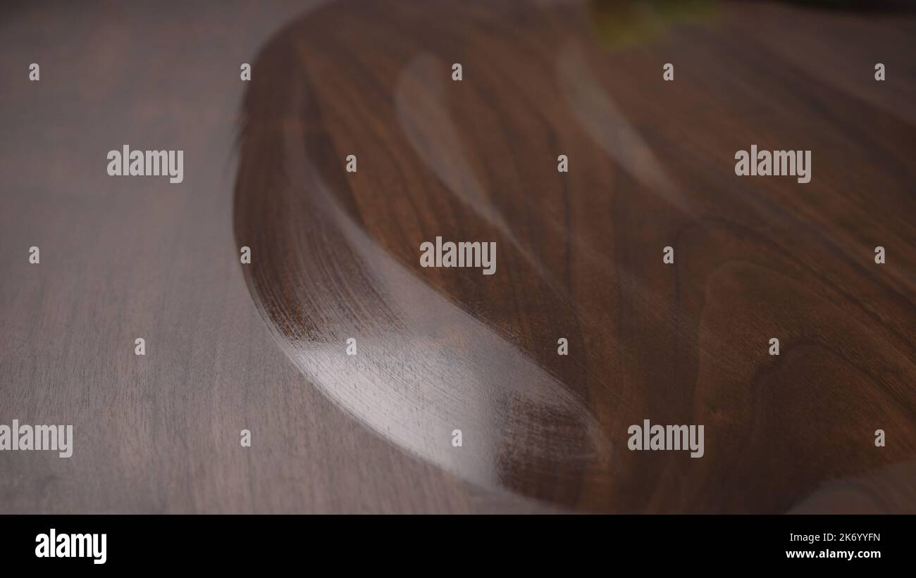 wet wiping walnut wood table with special solution closeup, wide photo Stock Photo - Alamy