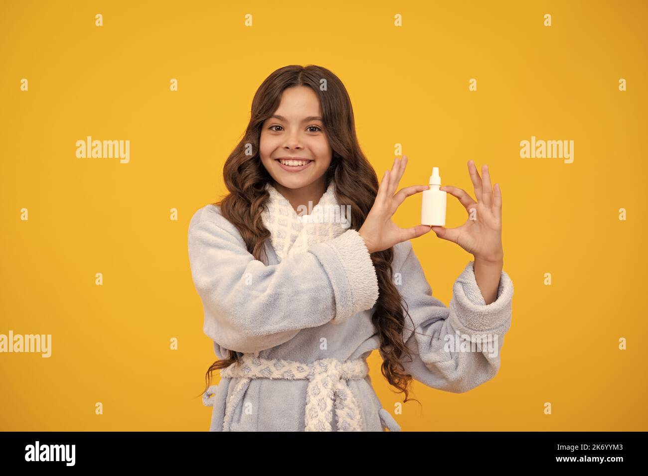 Happy child holds a medicine. Sick teen girl snuffle struggle with ...