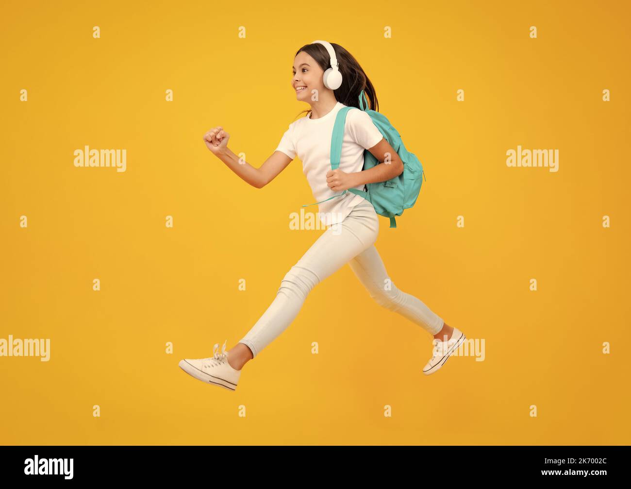 School leisure. Happy teenager portrait. School girl in headphones on ...