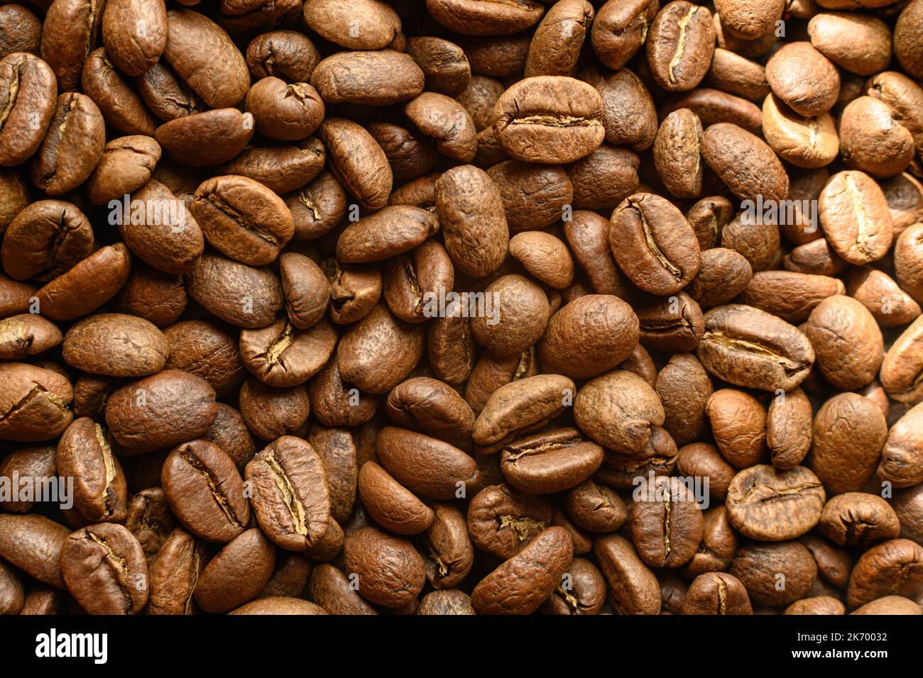 Black coffee beans with a slight haze from the steam, the texture of ...