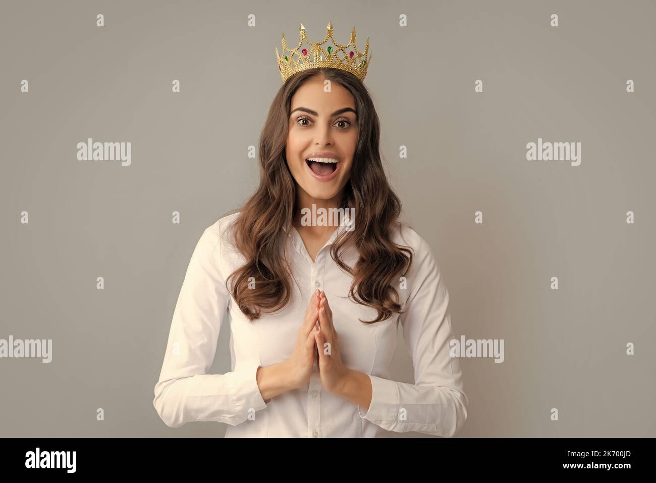 Young lovely woman in crown on gray background. Girl with queen crown ...