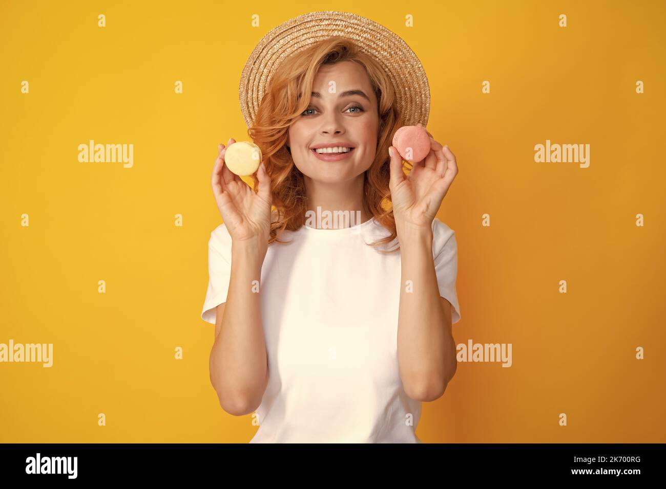 Beauty model girl taking colorful macaroons. Beautiful woman eating ...