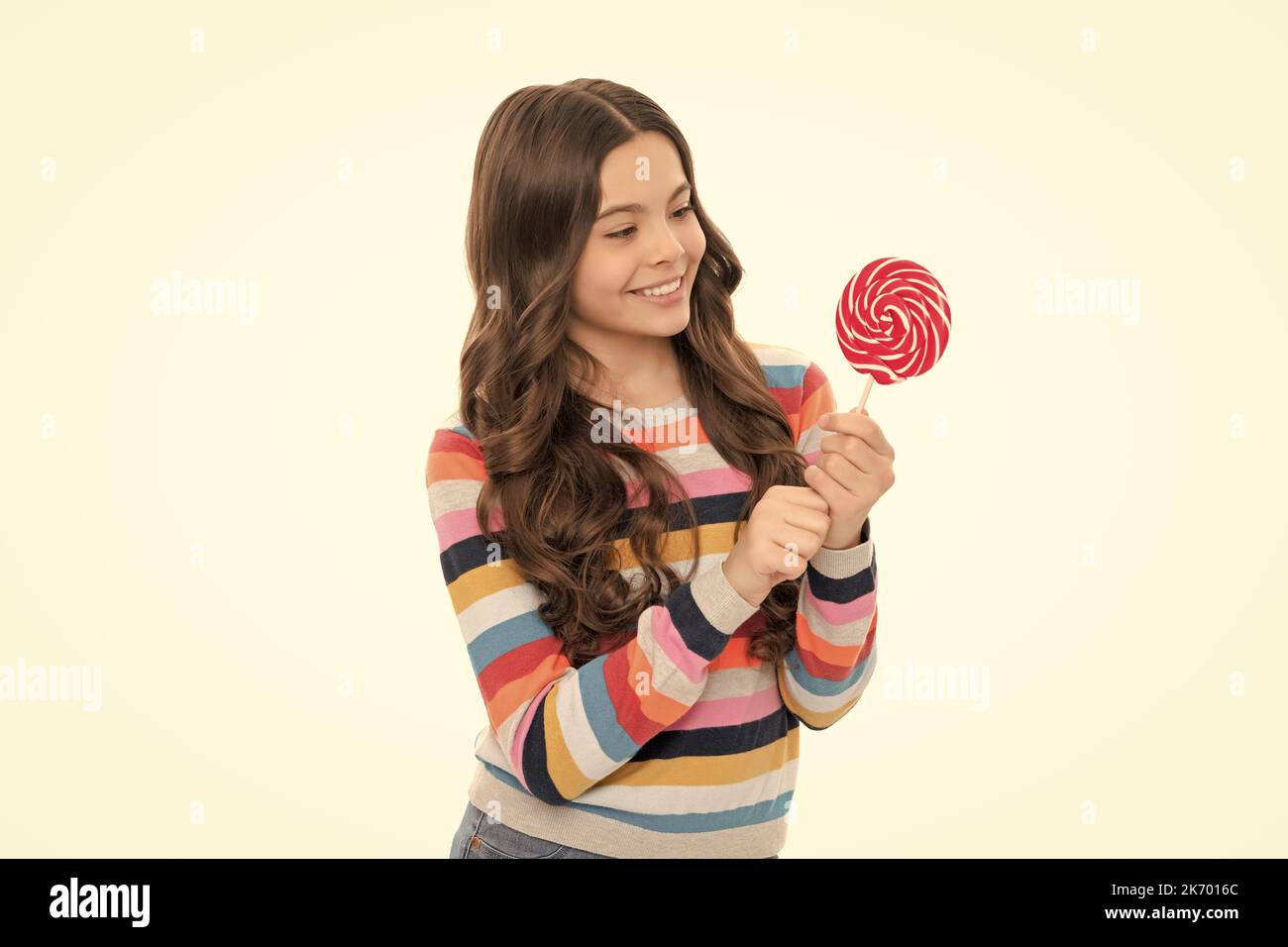 happy teen girl in sweater with lollipop candy on stick isolated on ...