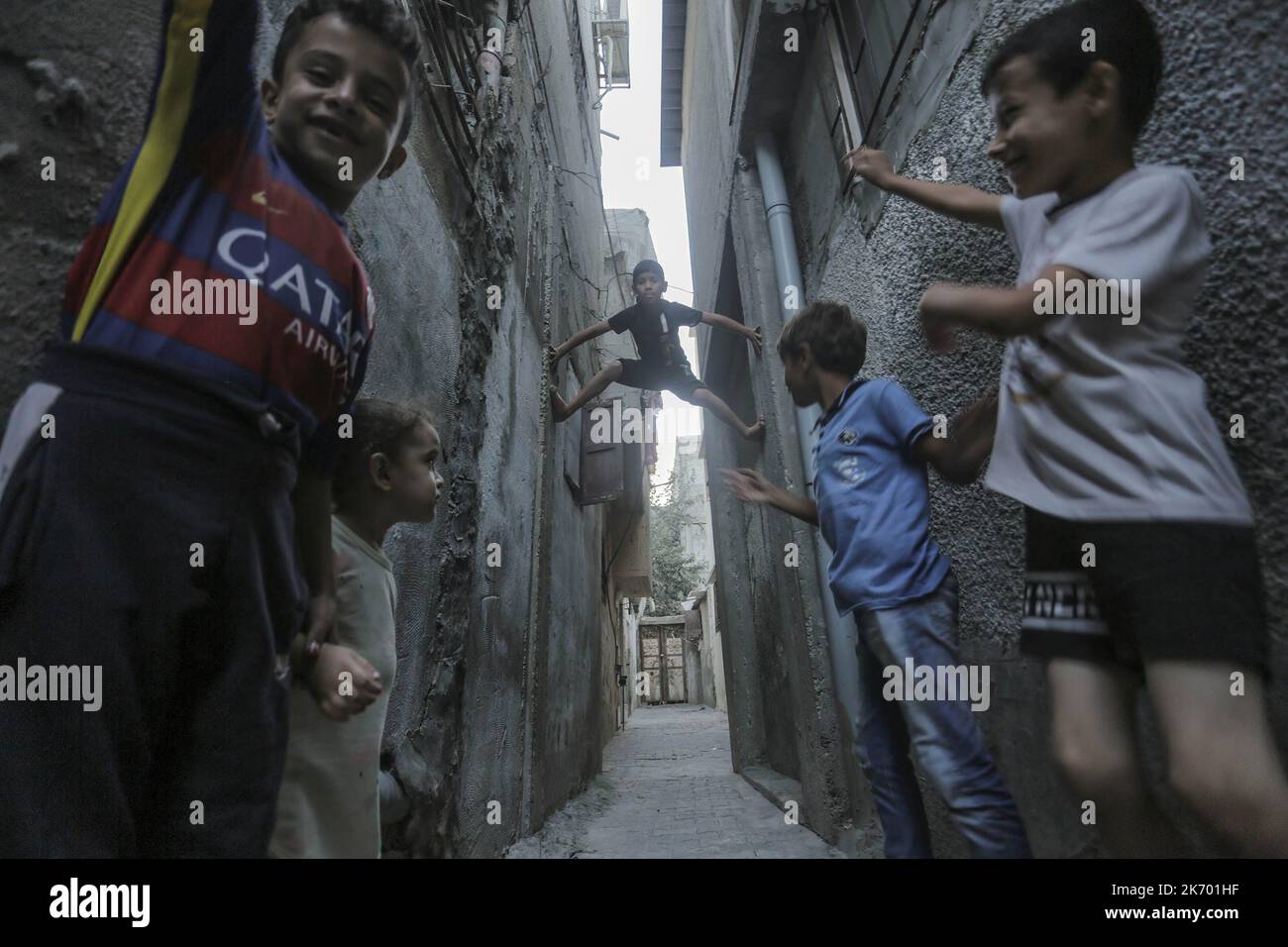 Palestinian refugee children play outside their house in the northern ...