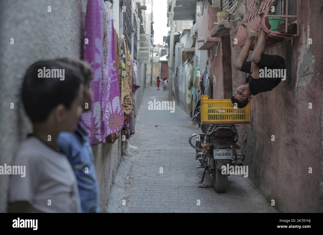 Palestinian refugee children play outside their house in the northern ...