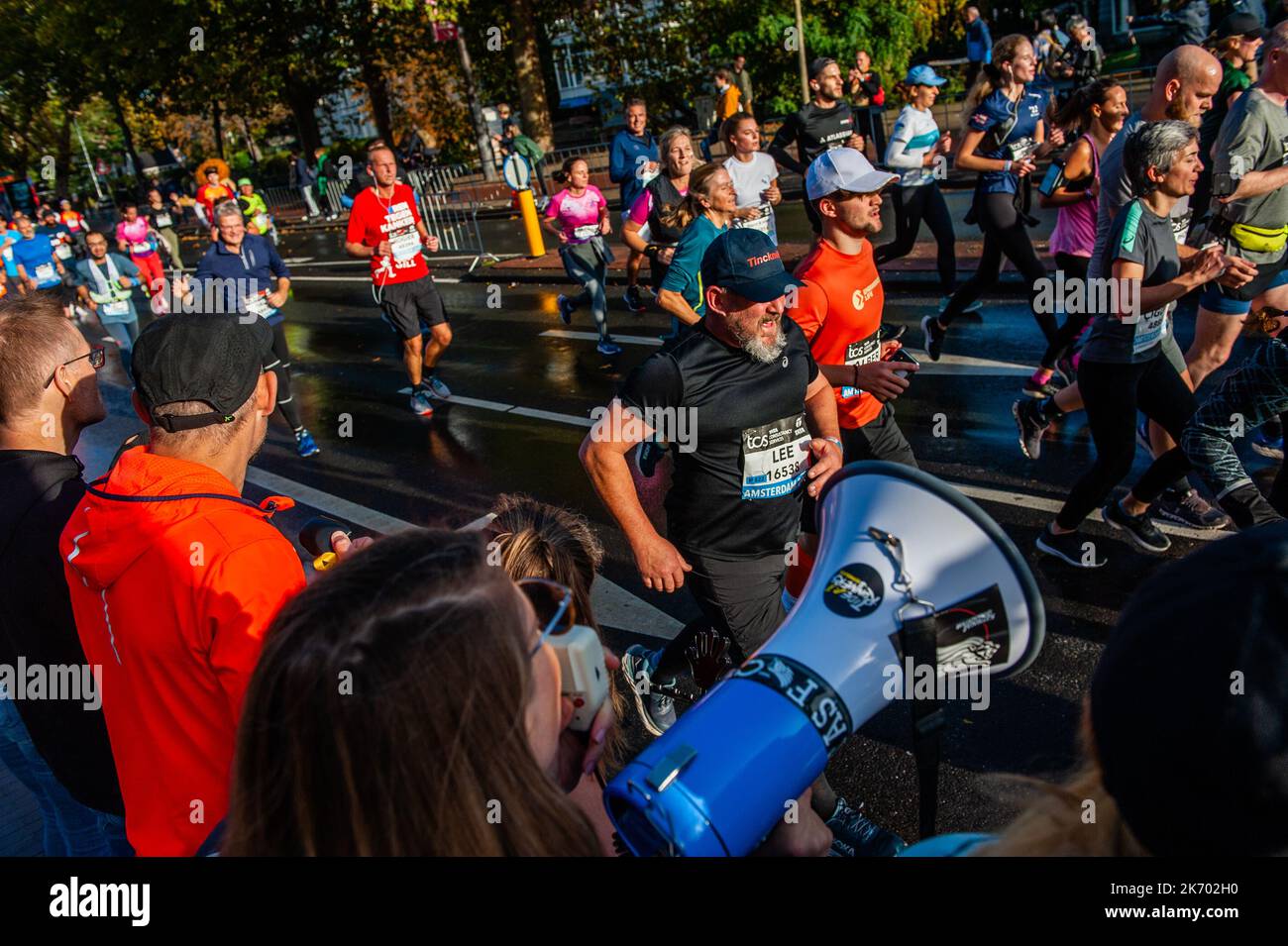 A woman in the audience is seen cheering the participants through a ...
