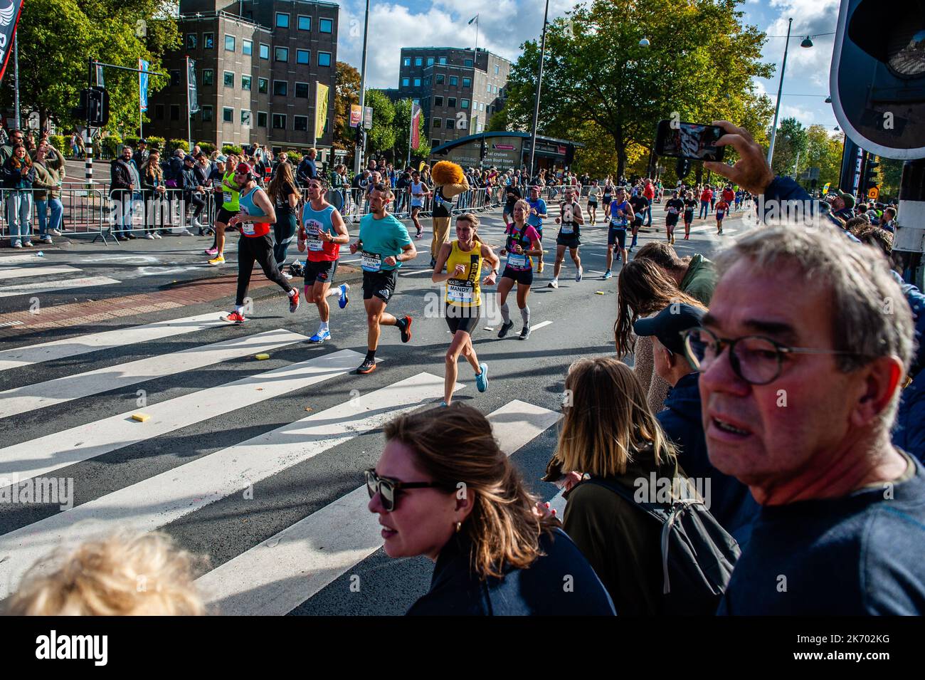 People are seen cheering the participants. More than 18,000 fanatics, a ...