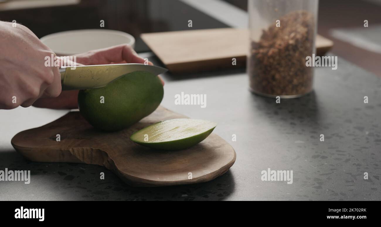 man cut green mango on olive wood board, wide photo Stock Photo - Alamy
