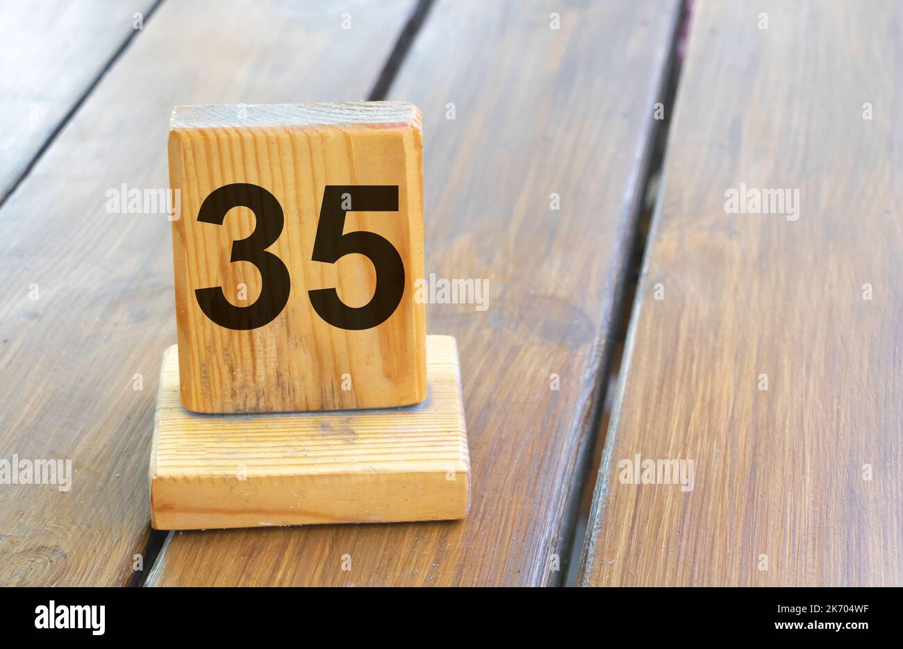 Wooden priority number 35 on a plank tab Stock Photo - Alamy