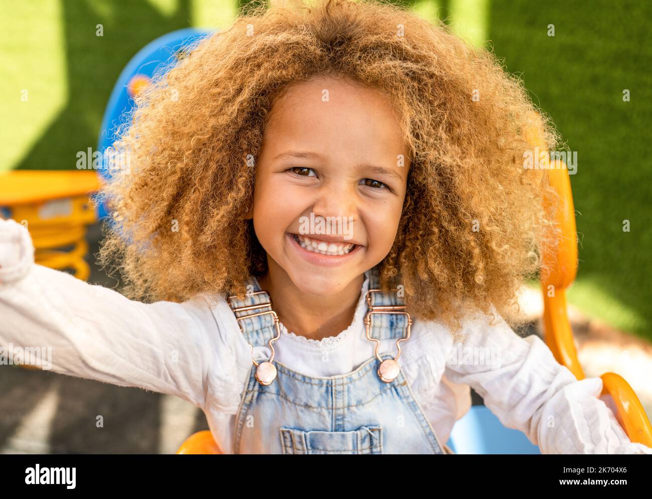 Close up portrait of cute African american child girl in a park ...