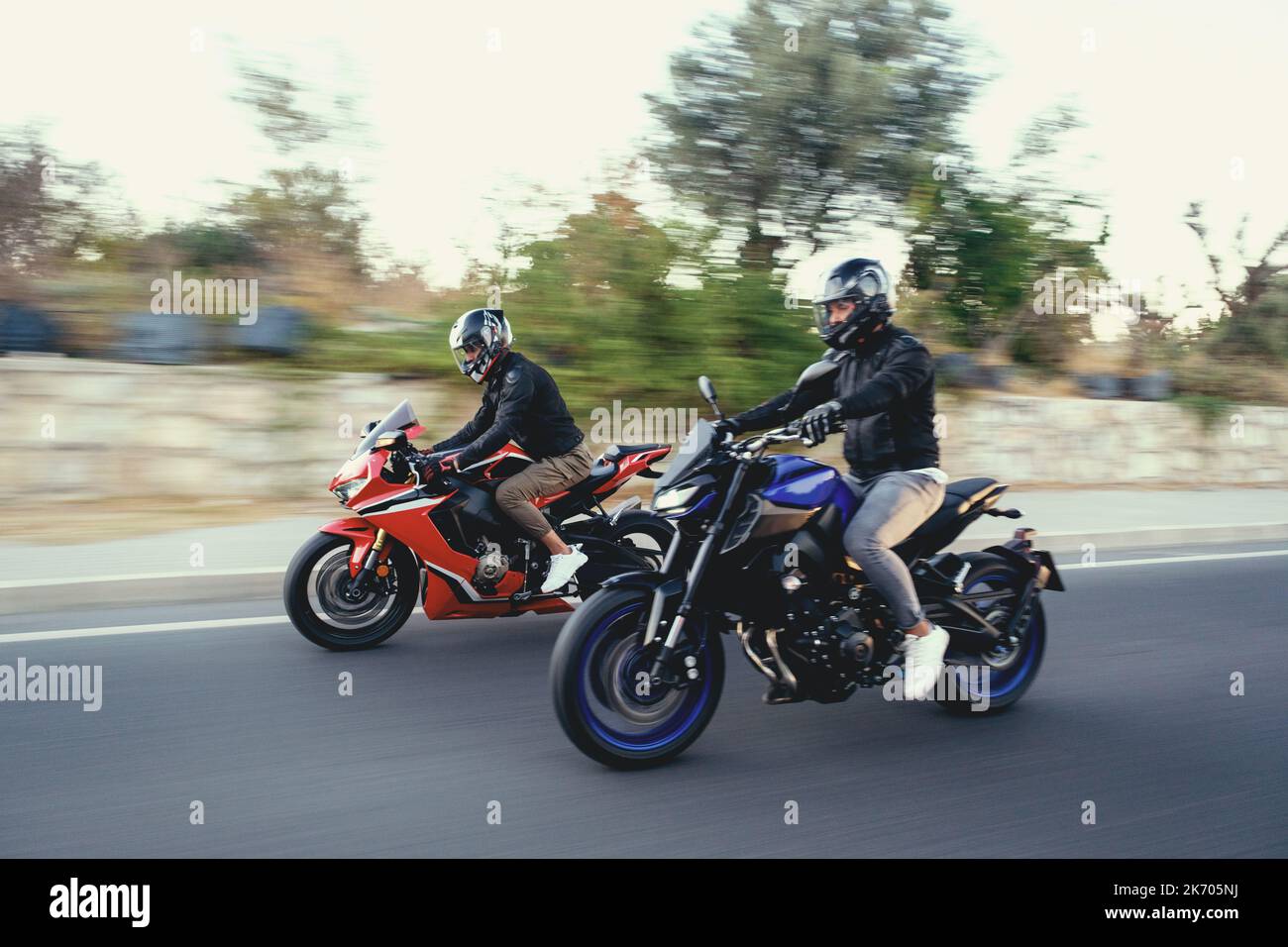 Two supersport race motorcycle riders going fast side by side on the ...