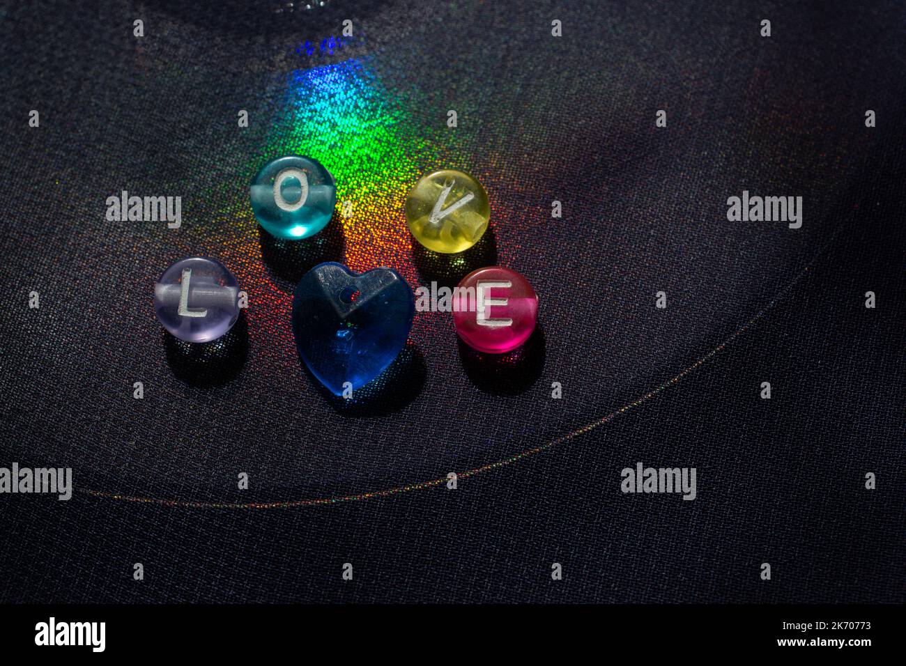 The word love with beads letters as love concept on colorful background ...