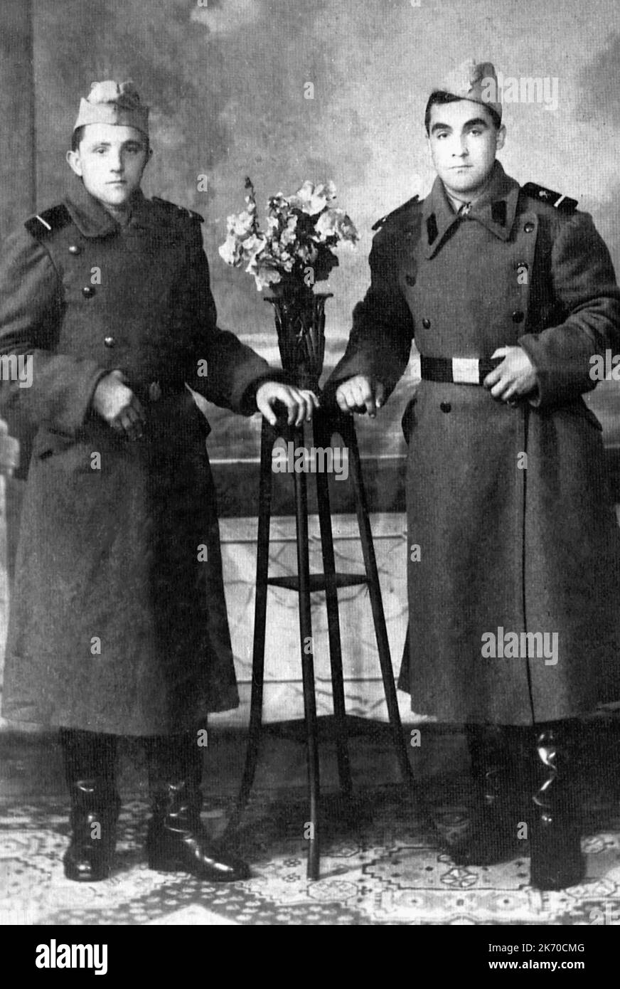 Two young soldiers posing for a photography. Black & white vintage ...