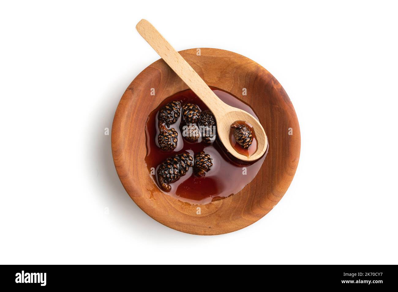 Pine cone jam in wooden bowl isolated on white background. Top view ...