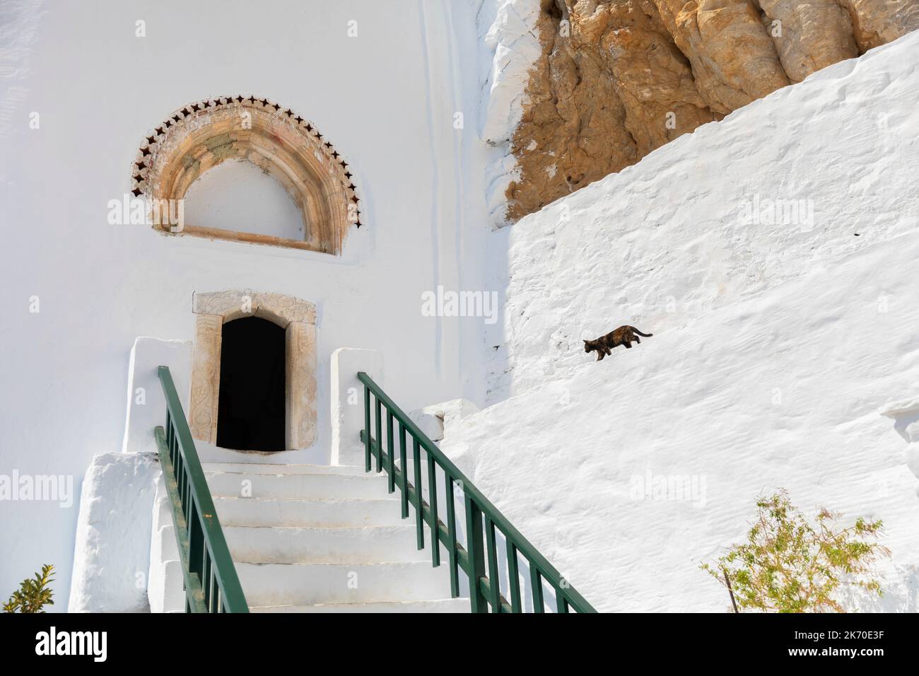 A cat walks on a wall at Hozoviotissa Monastery in Amorgos, Greece ...