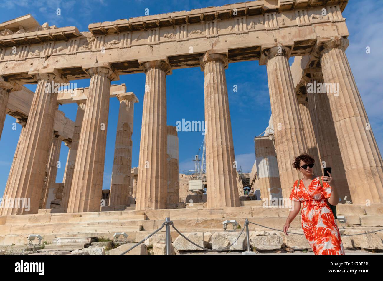 Woman looking at cell phone in front of Parthenon Stock Photo - Alamy