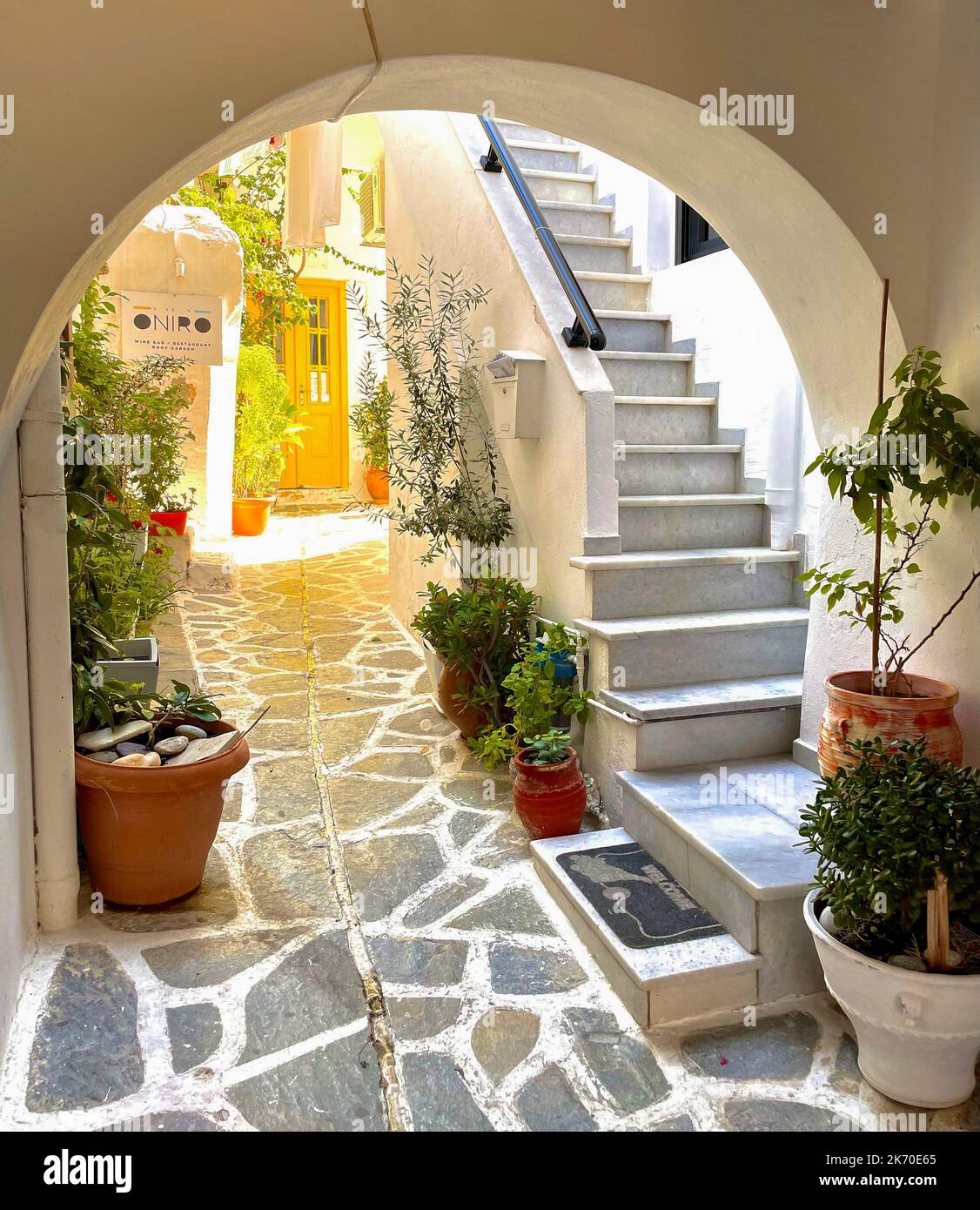 Stairs in archway in stucco building on Naxos, Greece Stock Photo - Alamy