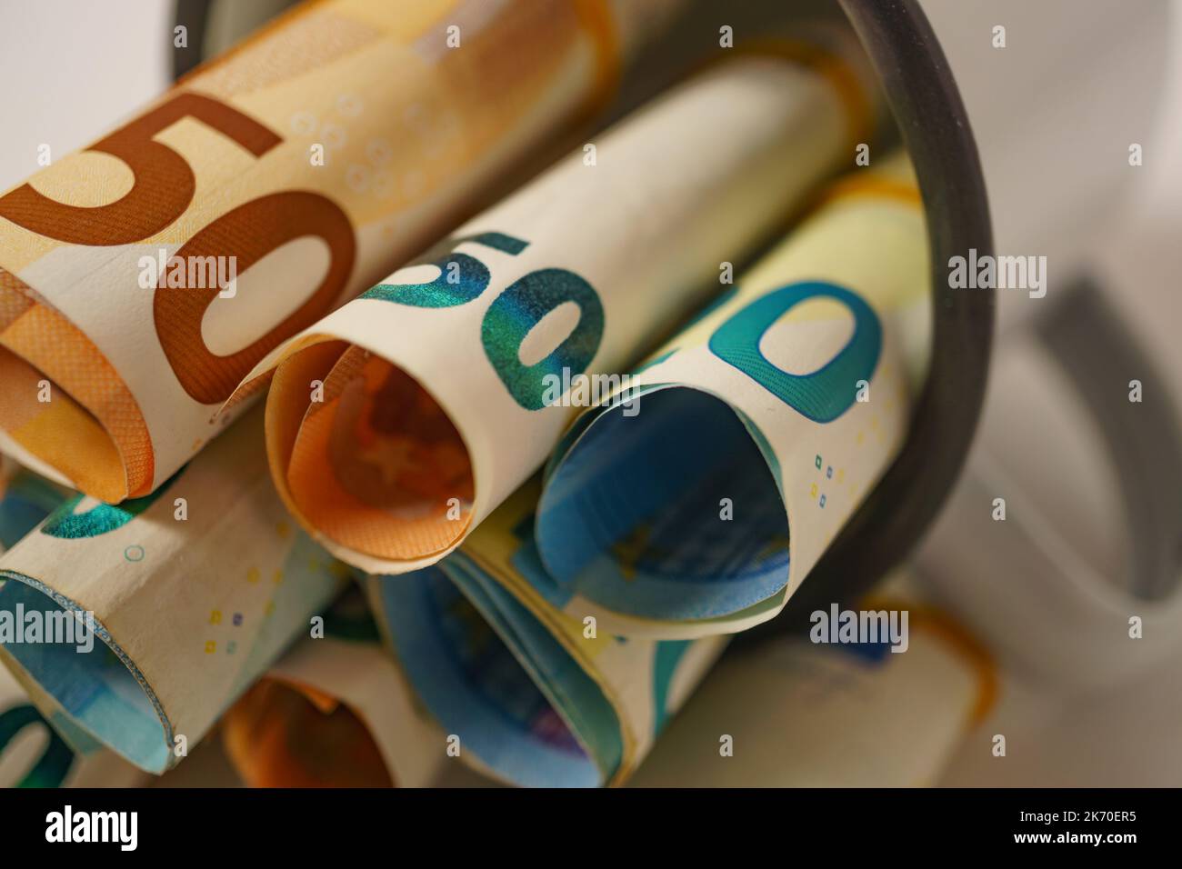 rolled euro banknotes stuffed into a white cup Stock Photo - Alamy