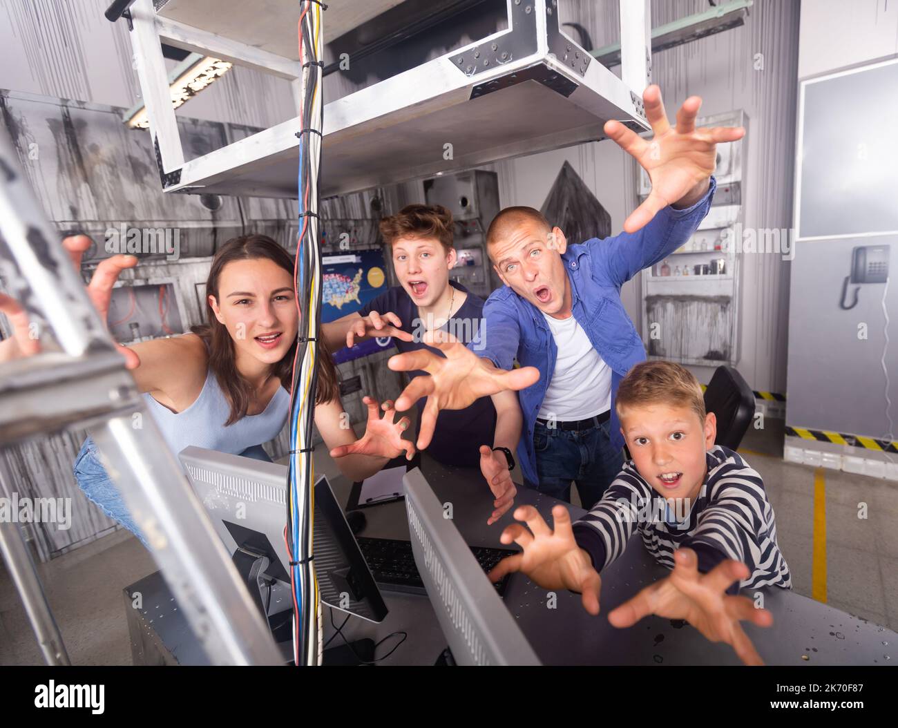 Friendly family has fun in the quest room, stylized as a laboratory ...