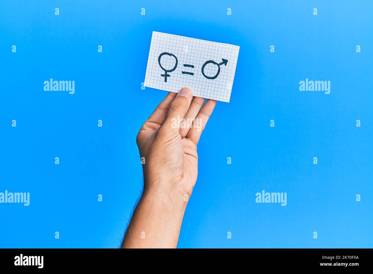 Hand of caucasian man holding paper with gender equality symbol message ...