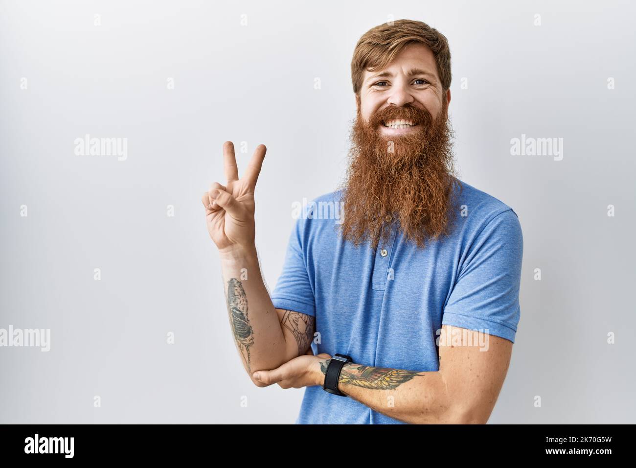 Caucasian man with long beard standing over isolated background smiling ...