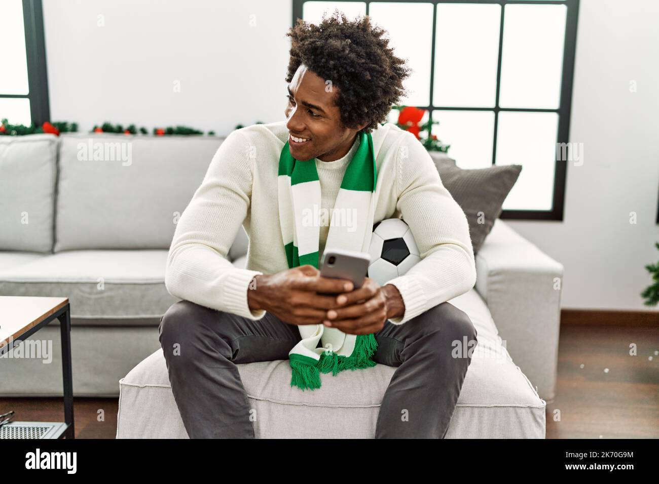 Young african american hooligan man using smartphone supporting soccer ...