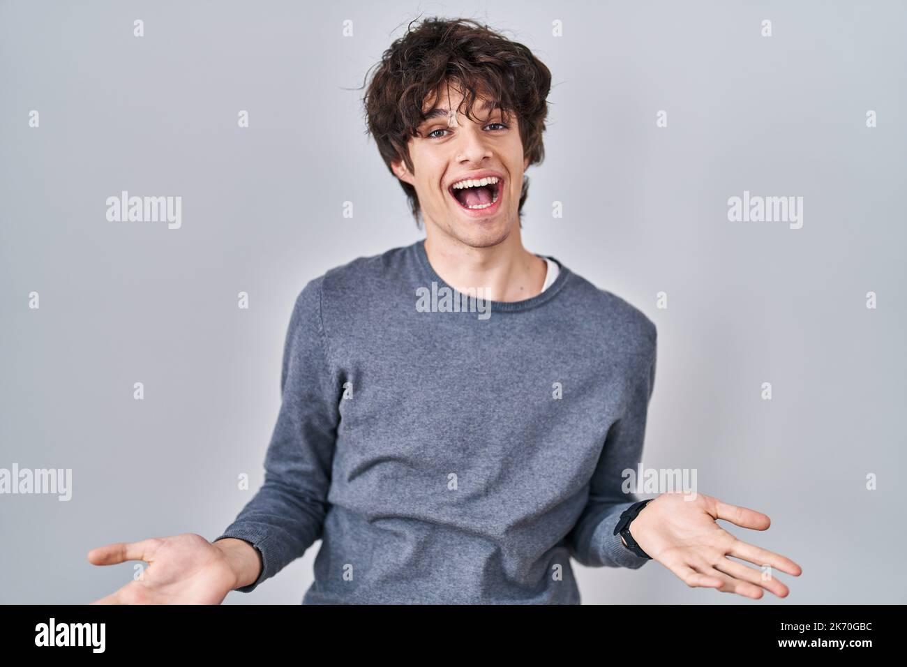 Young man standing over isolated background smiling cheerful with open ...