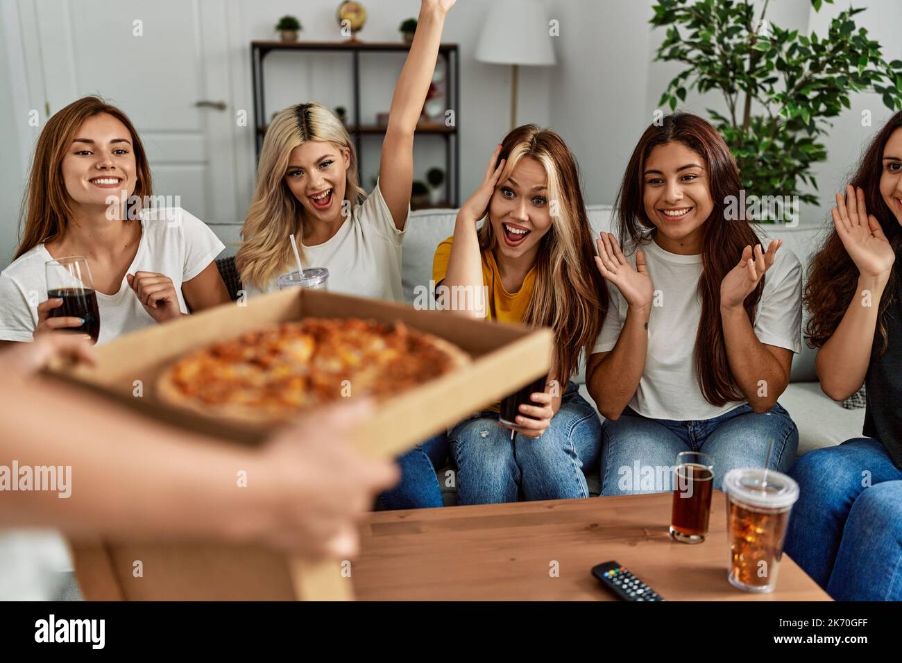 Group of young friends woman surprise for italian pizza sitting on the ...