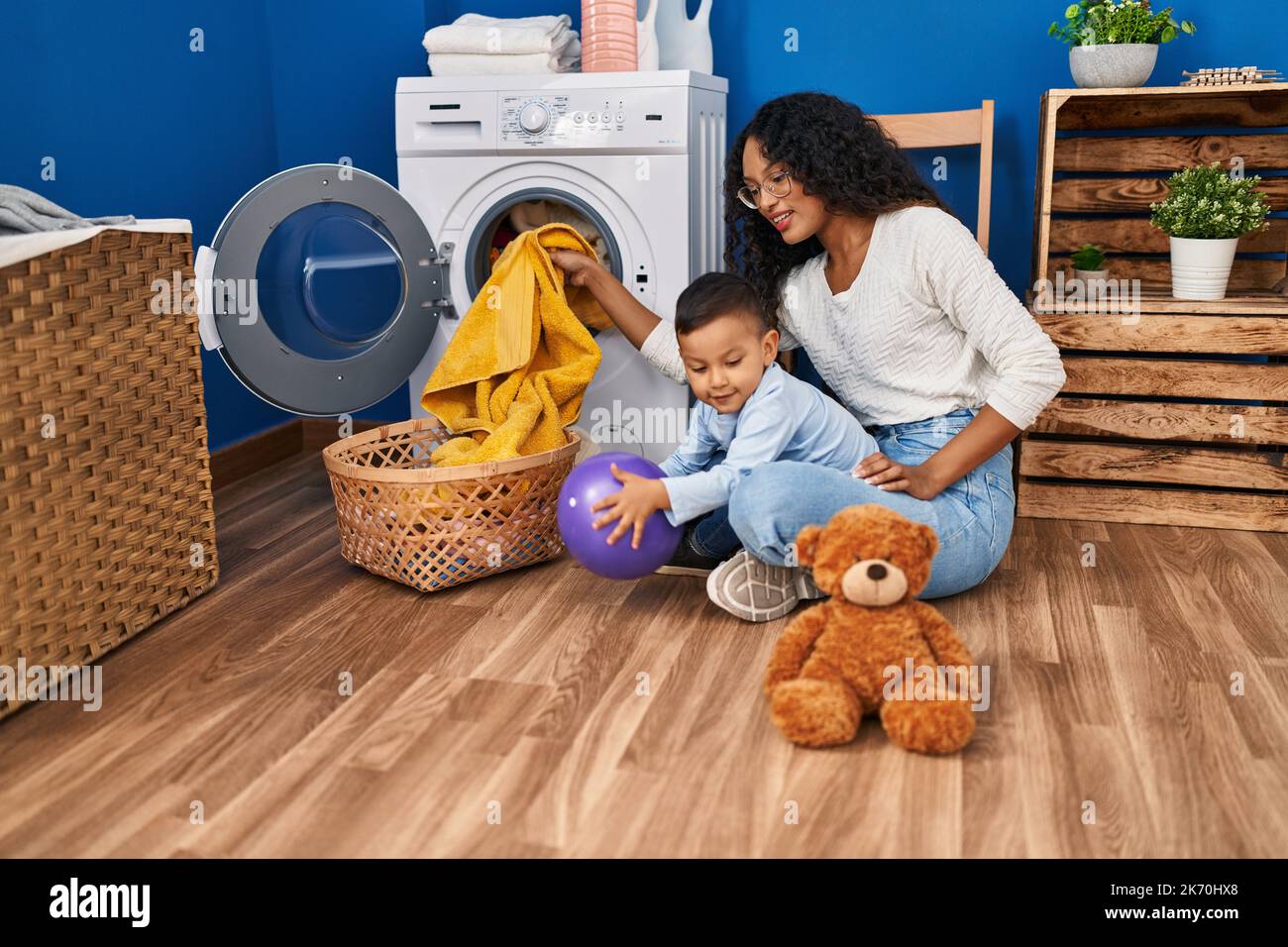 Mother and son smiling confident washing clothes at laundry room Stock ...
