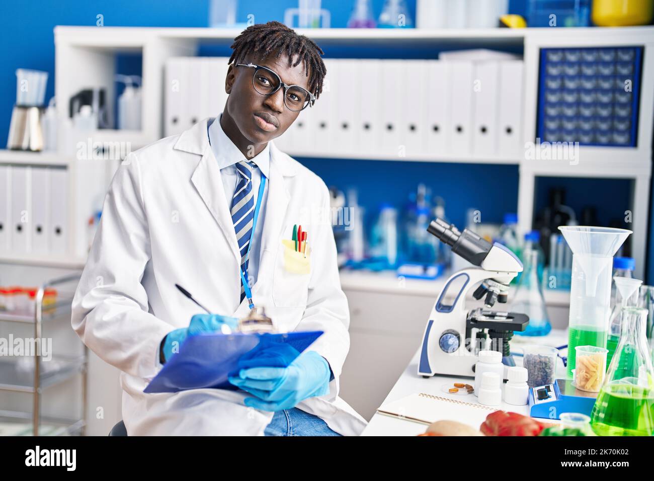 African american man scientist writing report at laboratory Stock Photo ...