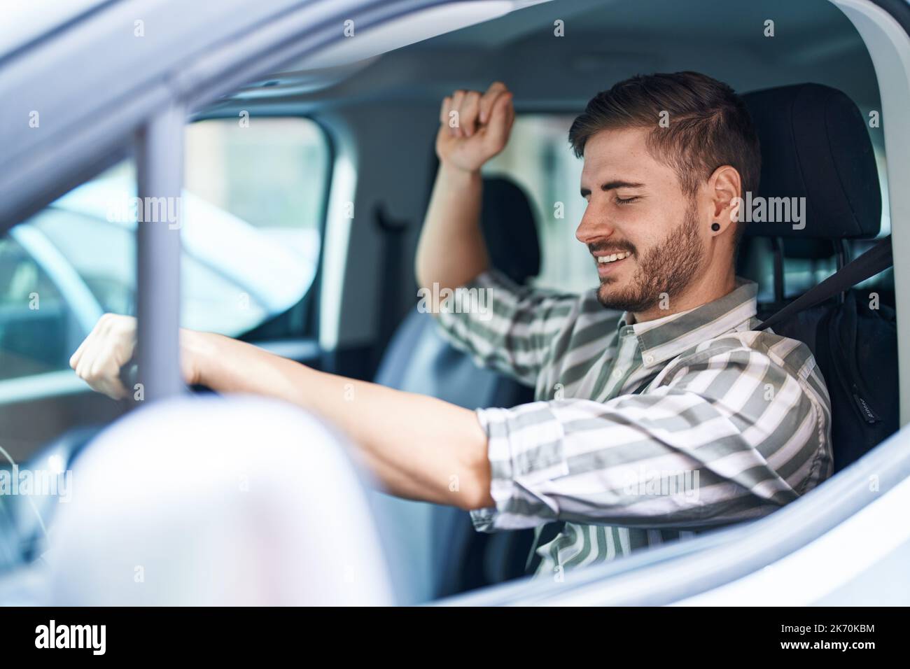 Man driving car dancing listening hi-res stock photography and images ...