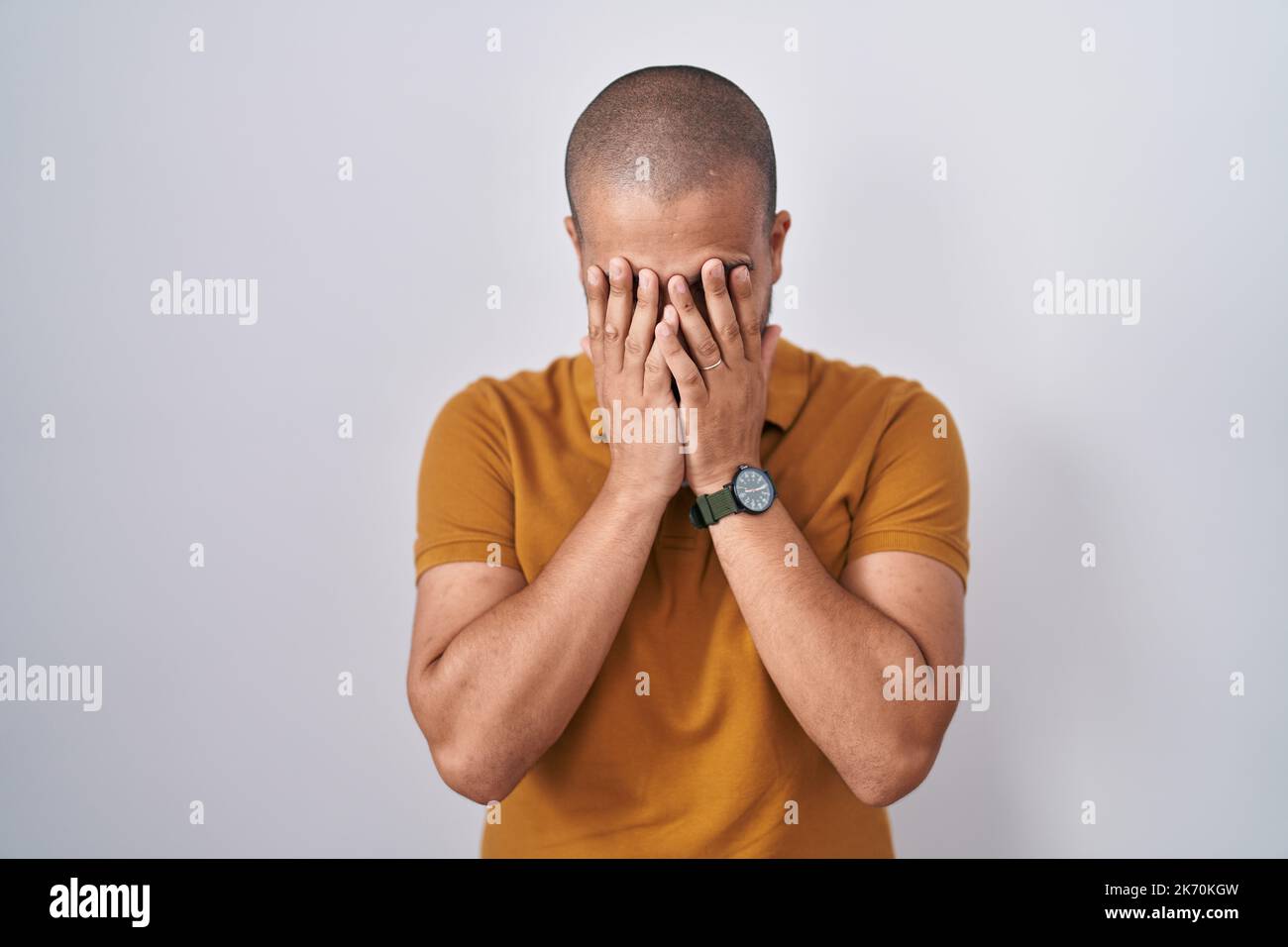 Hispanic man with beard standing over white background with sad ...