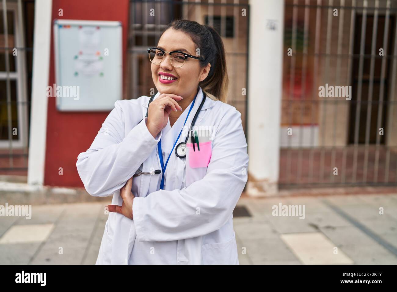 Young beautiful plus size woman doctor smiling confident standing with ...