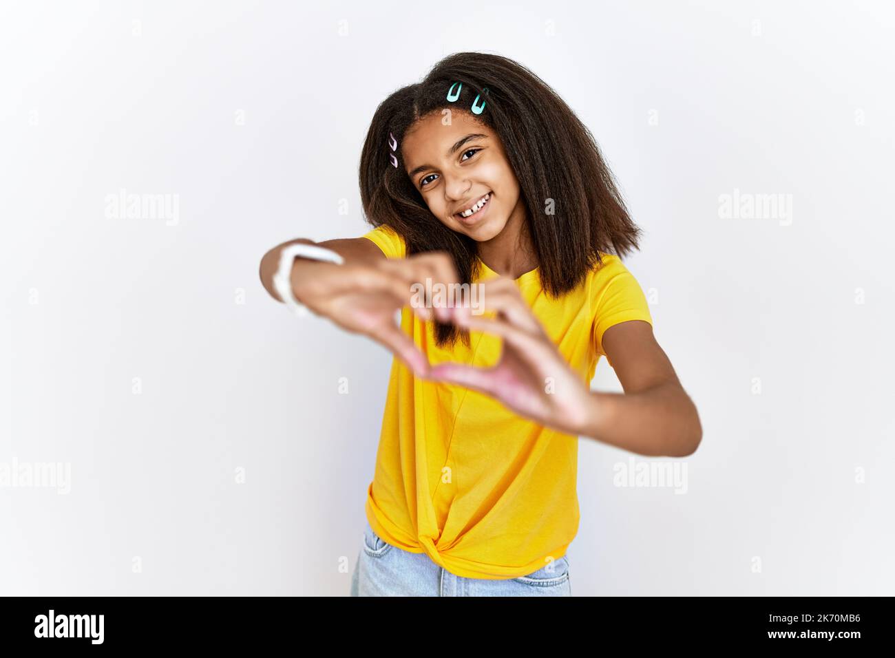 Young african american girl standing over white isolated background ...