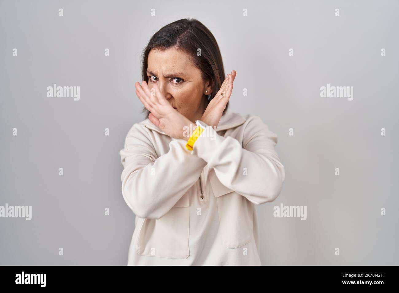 Middle age hispanic woman standing over isolated background rejection ...