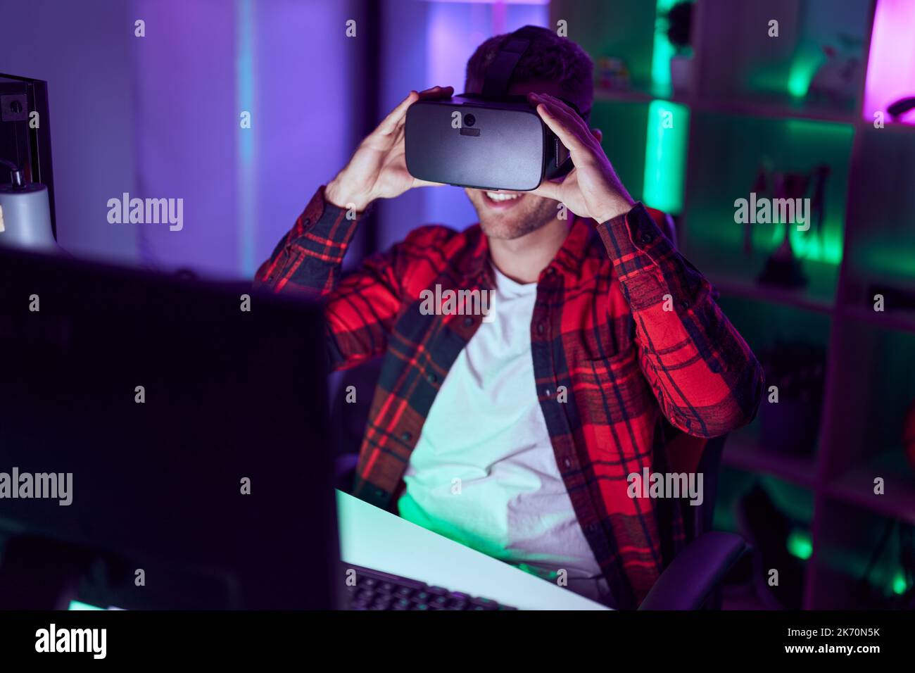 Young caucasian man streamer playing video game using virtual reality ...