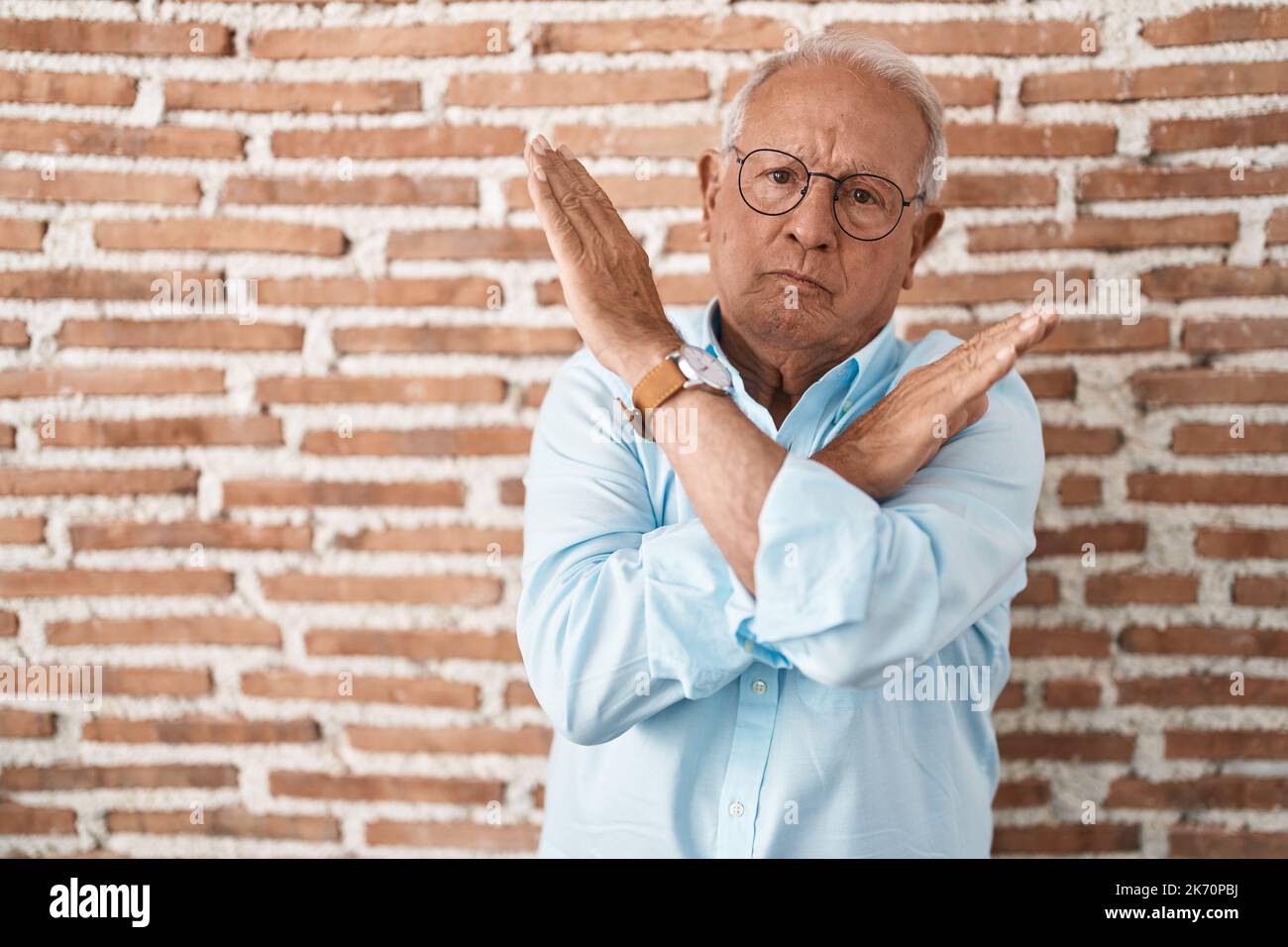 Senior Man With Grey Hair Standing Over Bricks Wall Rejection