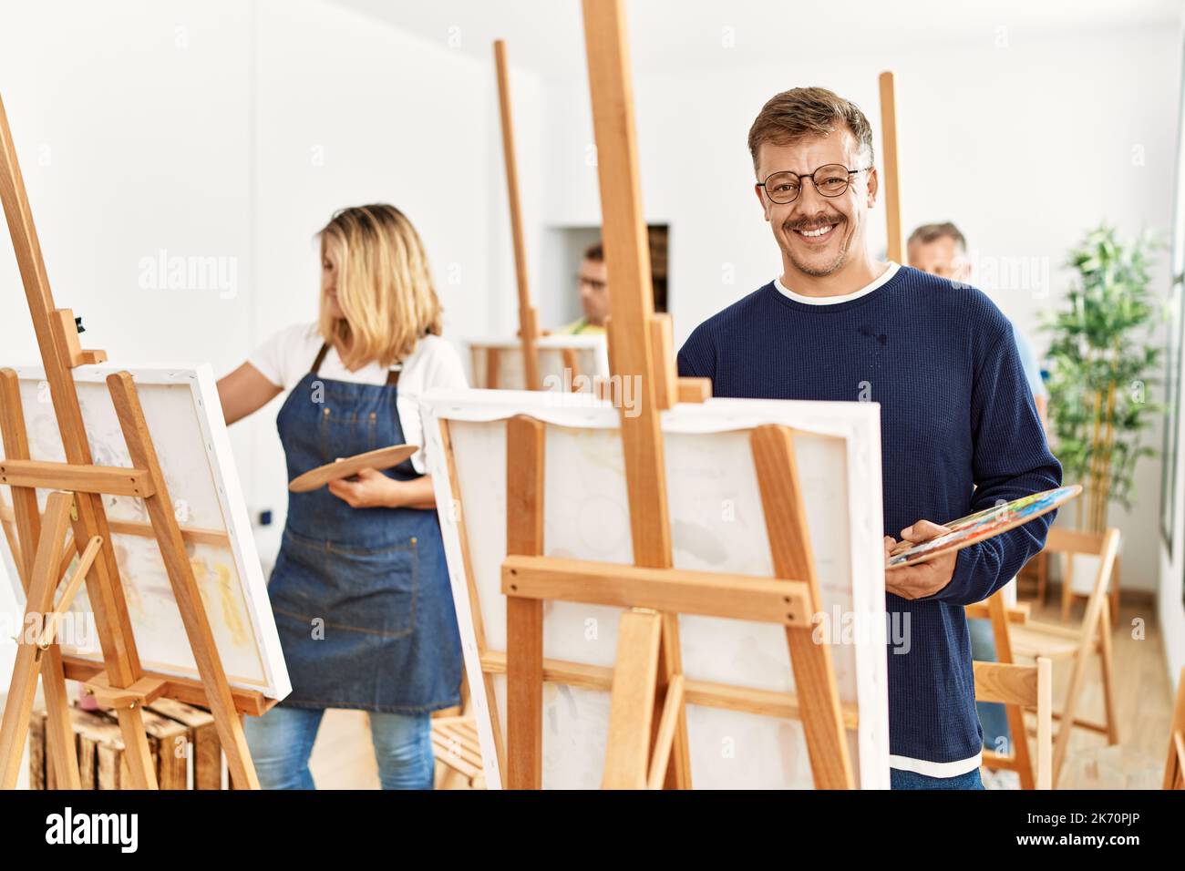 Group of middle age paint students drawing at art studio Stock Photo ...