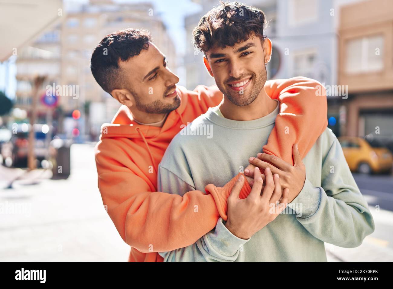 Two man couple hugging each other standing at street Stock Photo - Alamy