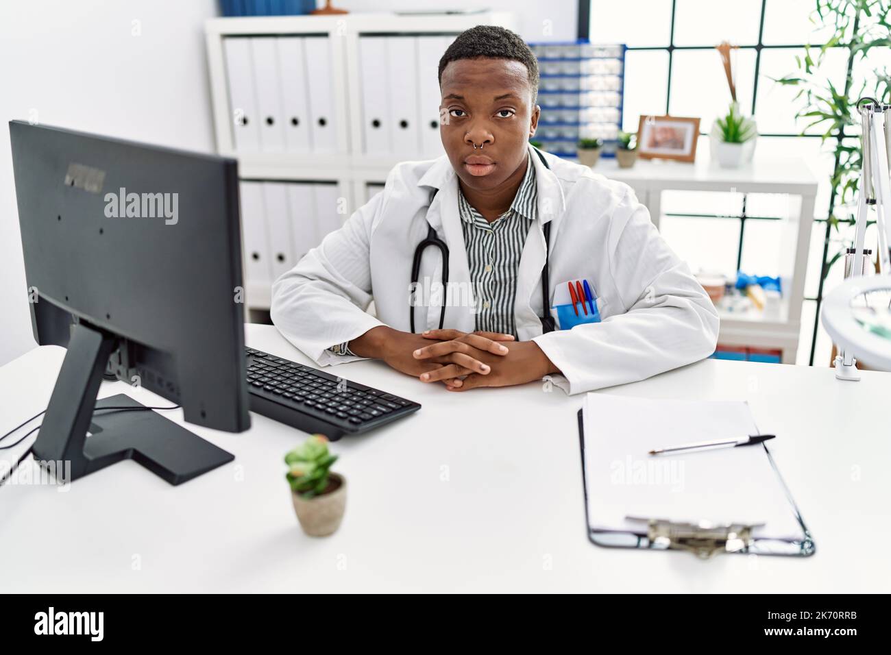 Young african man working as doctor at medical clinic Stock Photo - Alamy