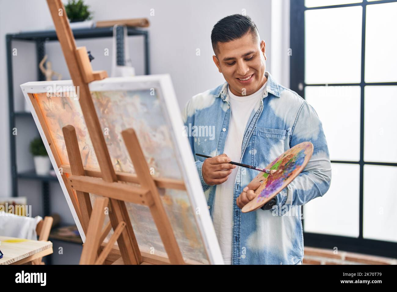 Young latin man artist smiling confident drawing at art studio Stock ...
