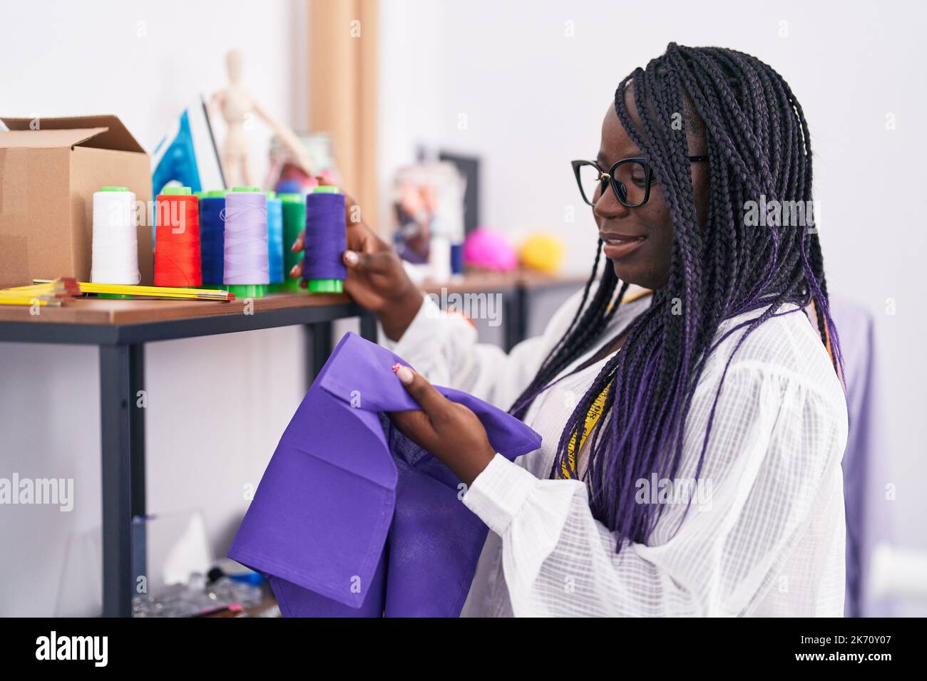 African american woman tailor smiling confident holding cloth and ...