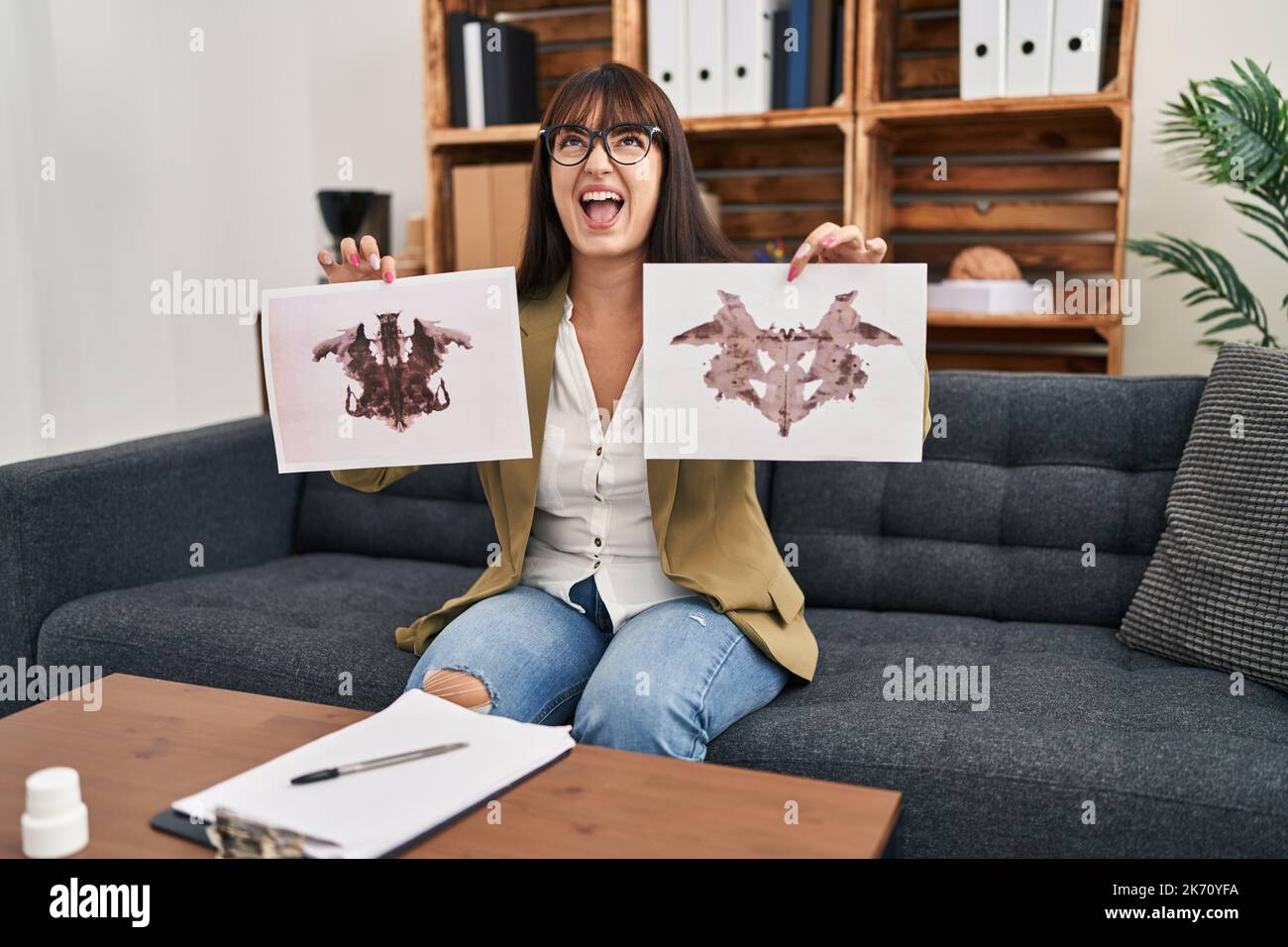 Young therapist woman working with rorschach test at psychology clinic ...
