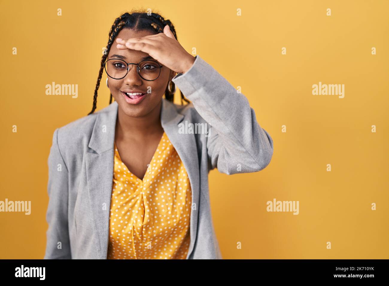African american woman with braids standing over yellow background very ...