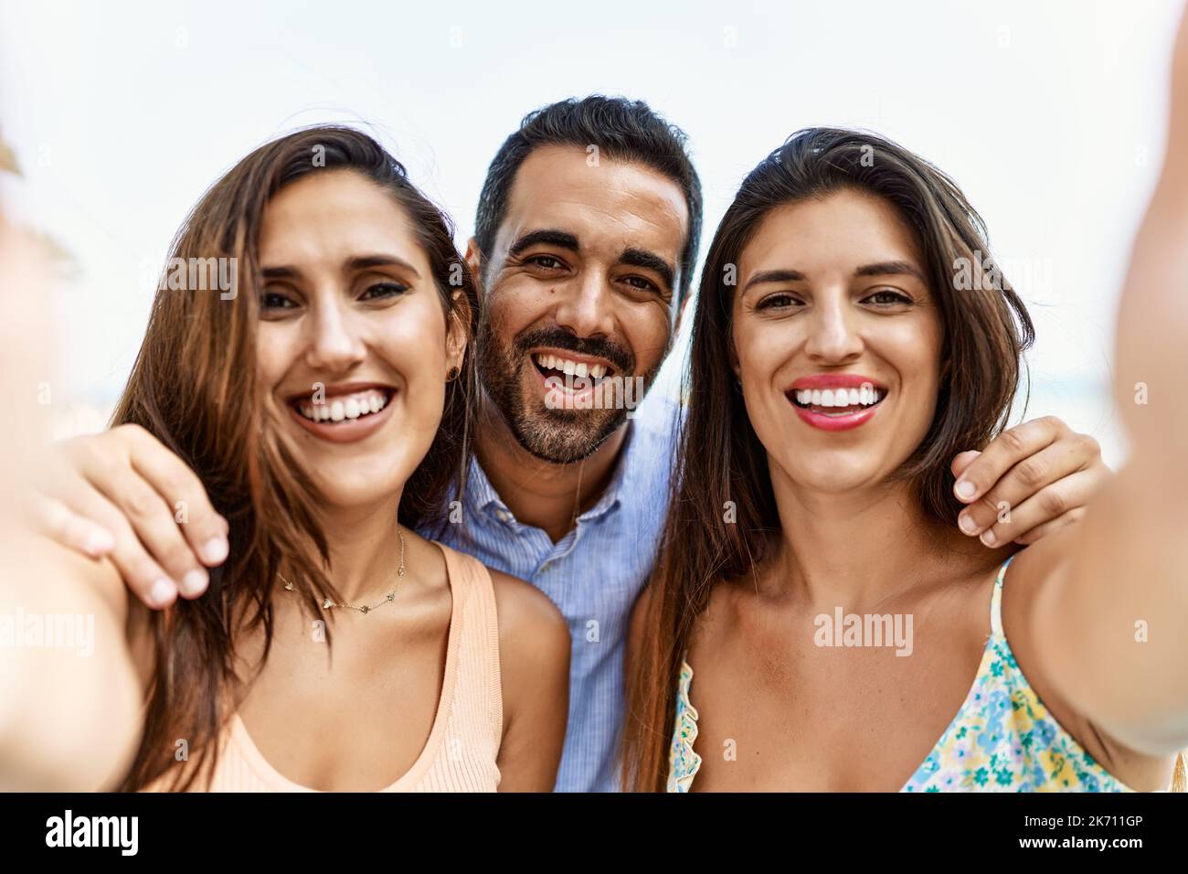 Three young hispanic friends smiling happy and hugging make selfie by ...